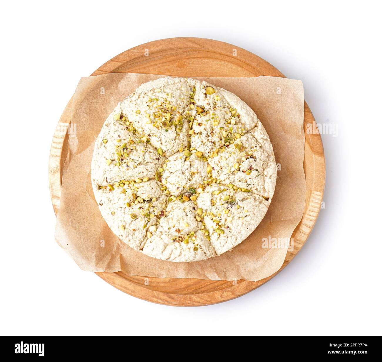 Plate of tasty Tahini halva with pistachios on white background Stock Photo - Alamy