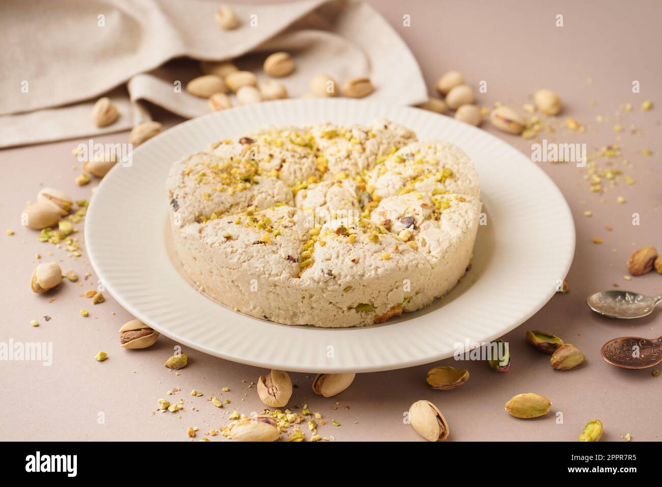 Plate of tasty Tahini halva with pistachios on beige background Stock ...