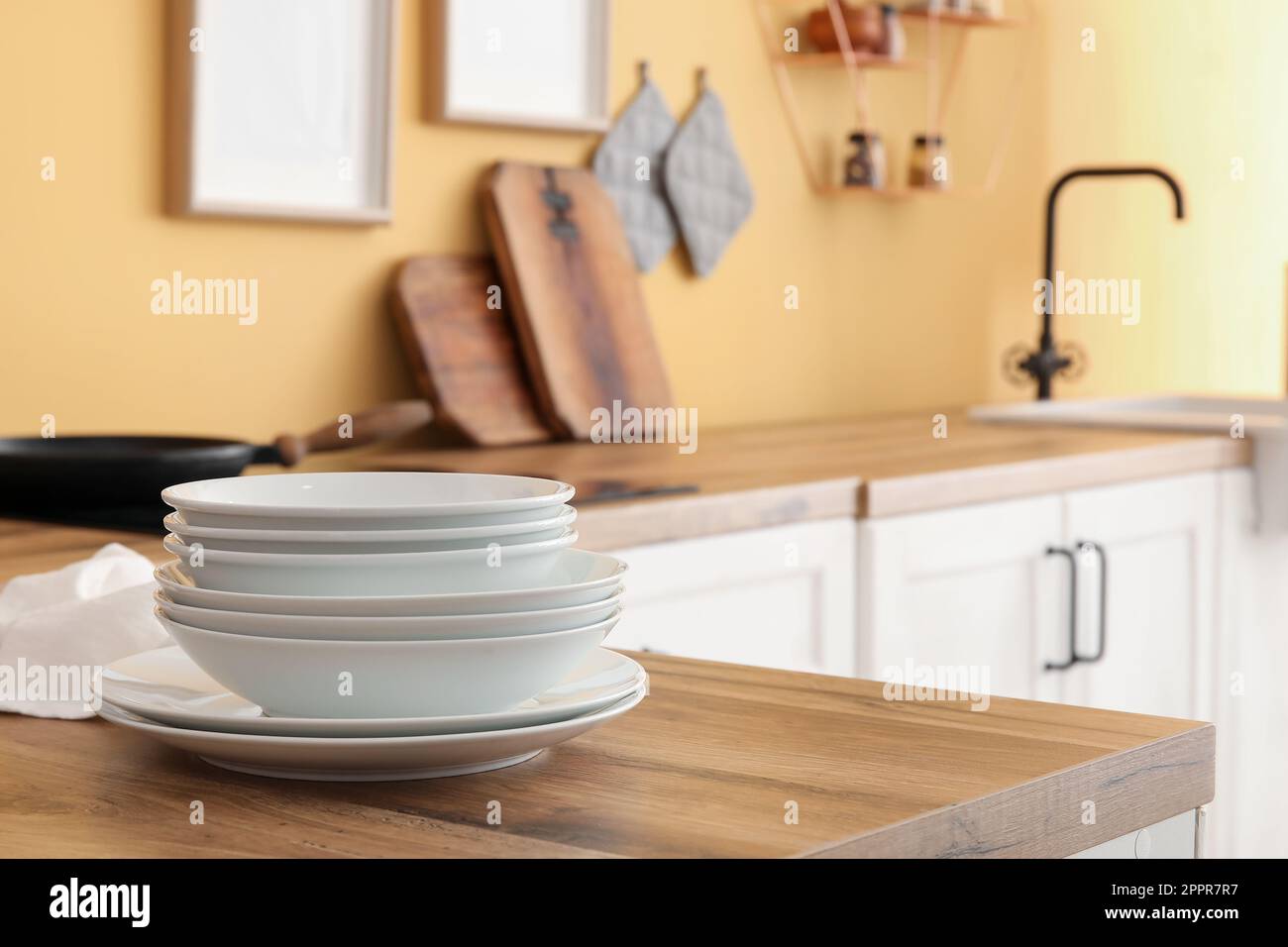 Counter with plates on kitchen Stock Photo - Alamy