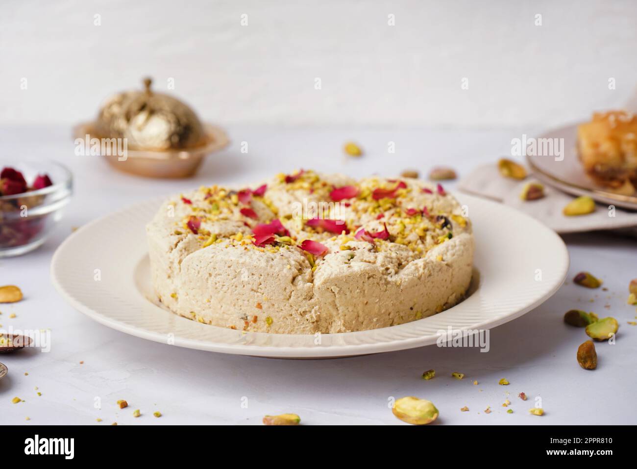 Plate of tasty Tahini halva with pistachios on light background Stock ...