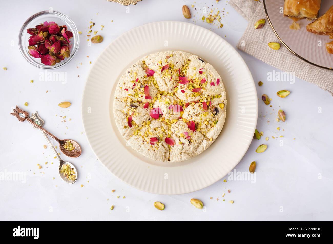 Plate of tasty Tahini halva with pistachios on light background Stock ...