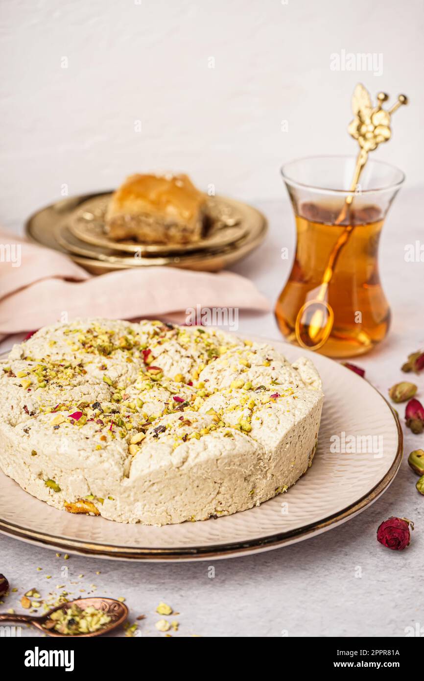 Plate of tasty Tahini halva with pistachios on light background Stock ...