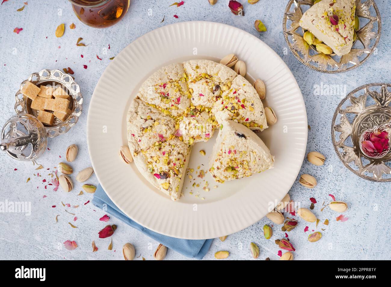 Plate of tasty Tahini halva with pistachios on light background Stock ...