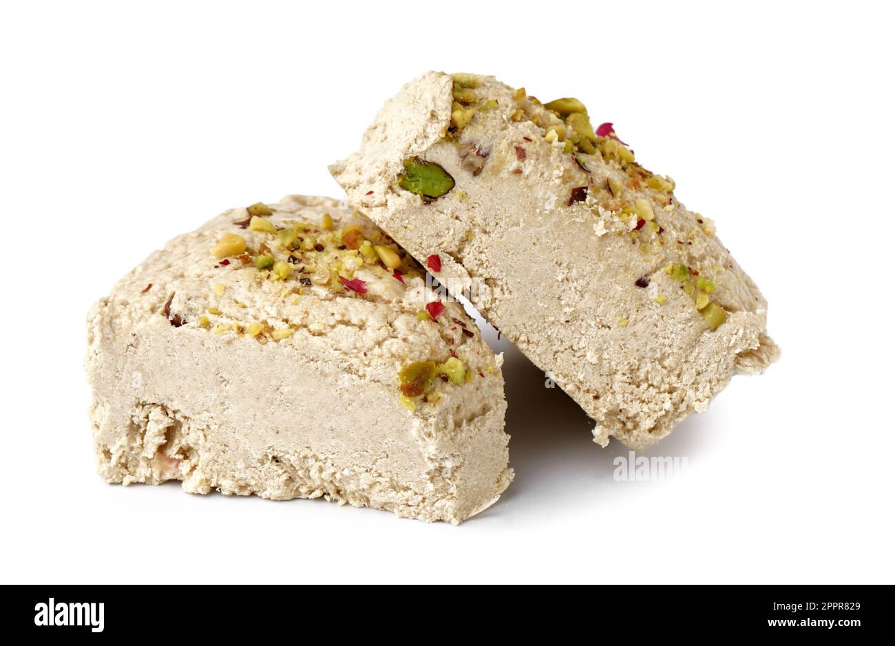 Pieces of tasty Tahini halva with pistachios on white background Stock Photo - Alamy