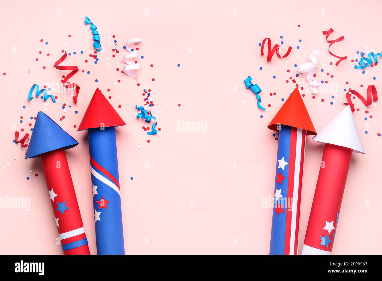 Firework rockets, confetti and serpentine for Independence Day on pink ...