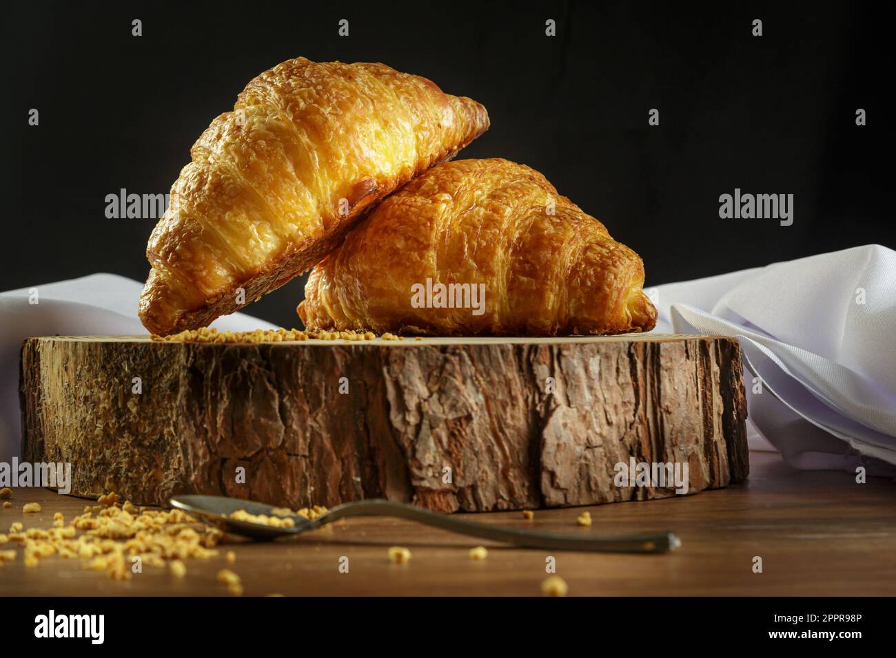 Delicious croissants on wooden trunk, with white towel around, seed ...