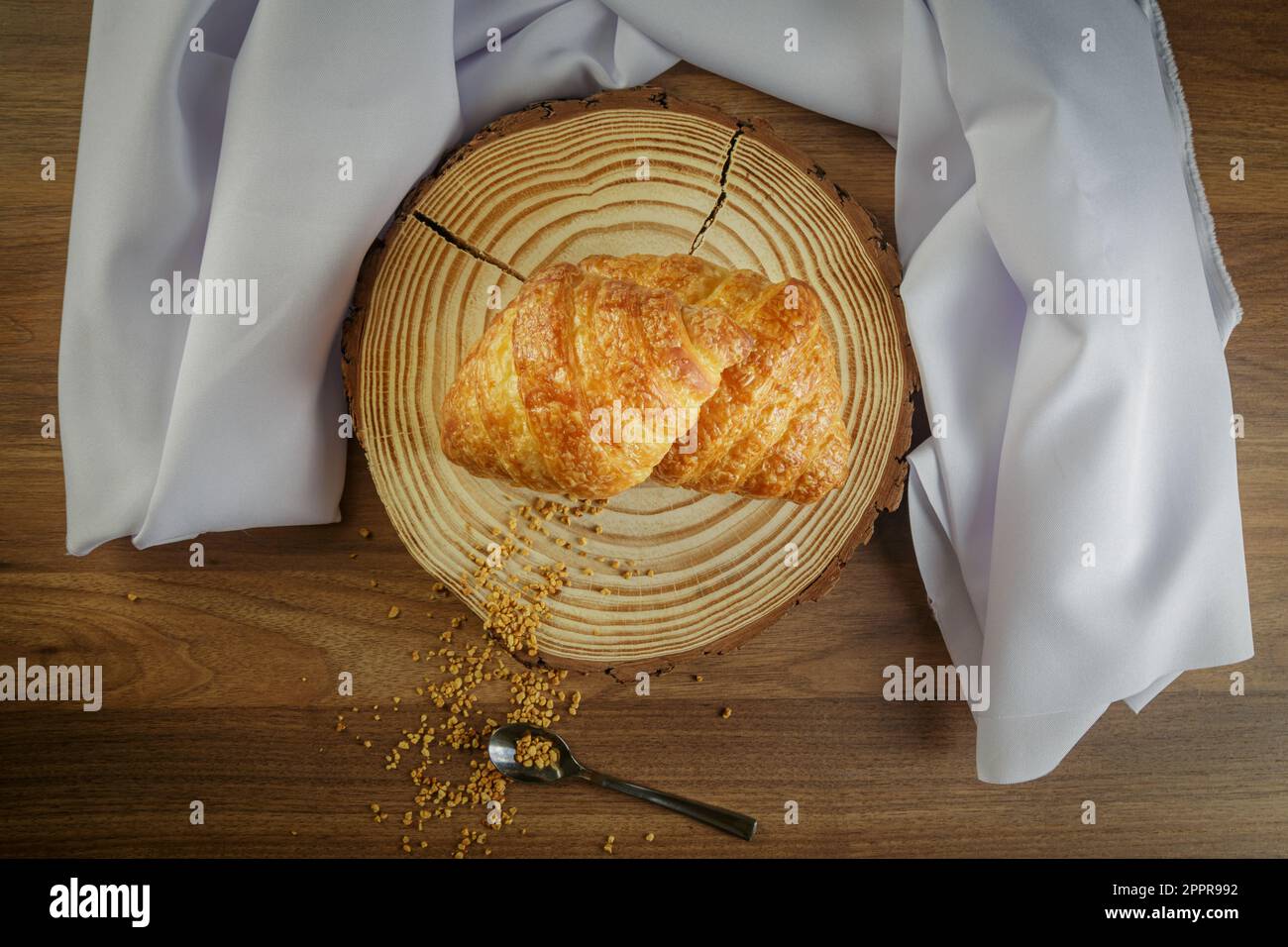 Delicious croissants on wooden trunk, with white towel around, seed ...
