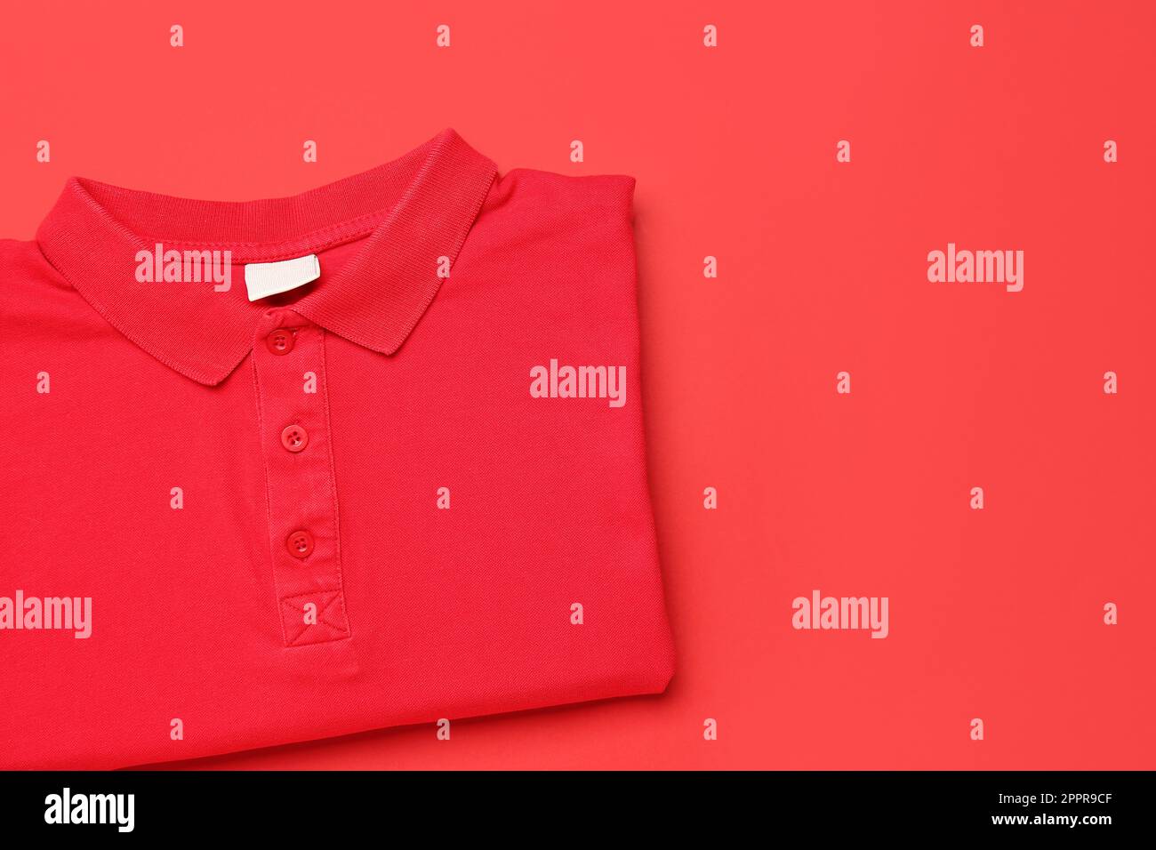 Folded red t-shirt on color background Stock Photo - Alamy