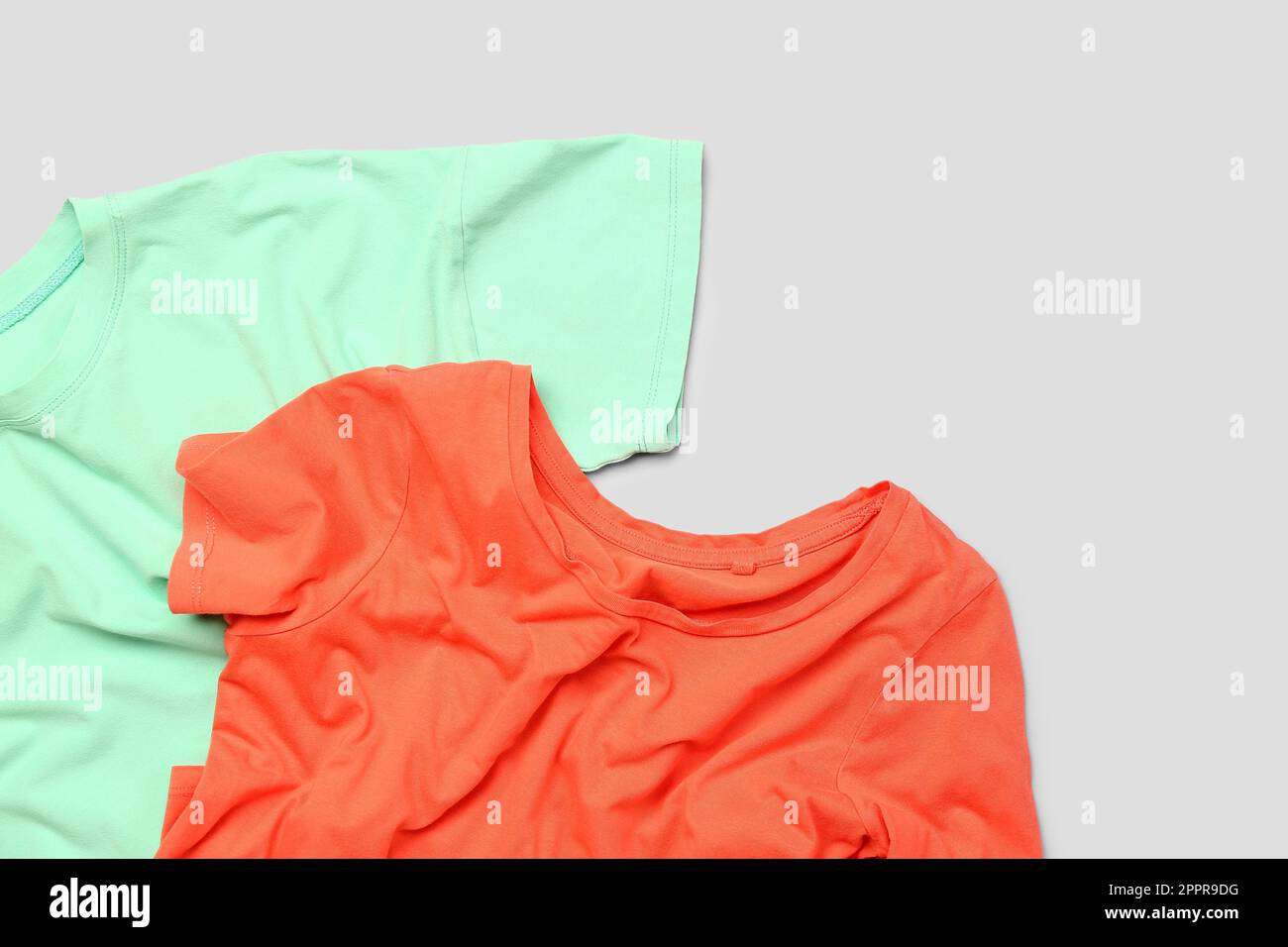 Crumpled t-shirts on light background Stock Photo - Alamy