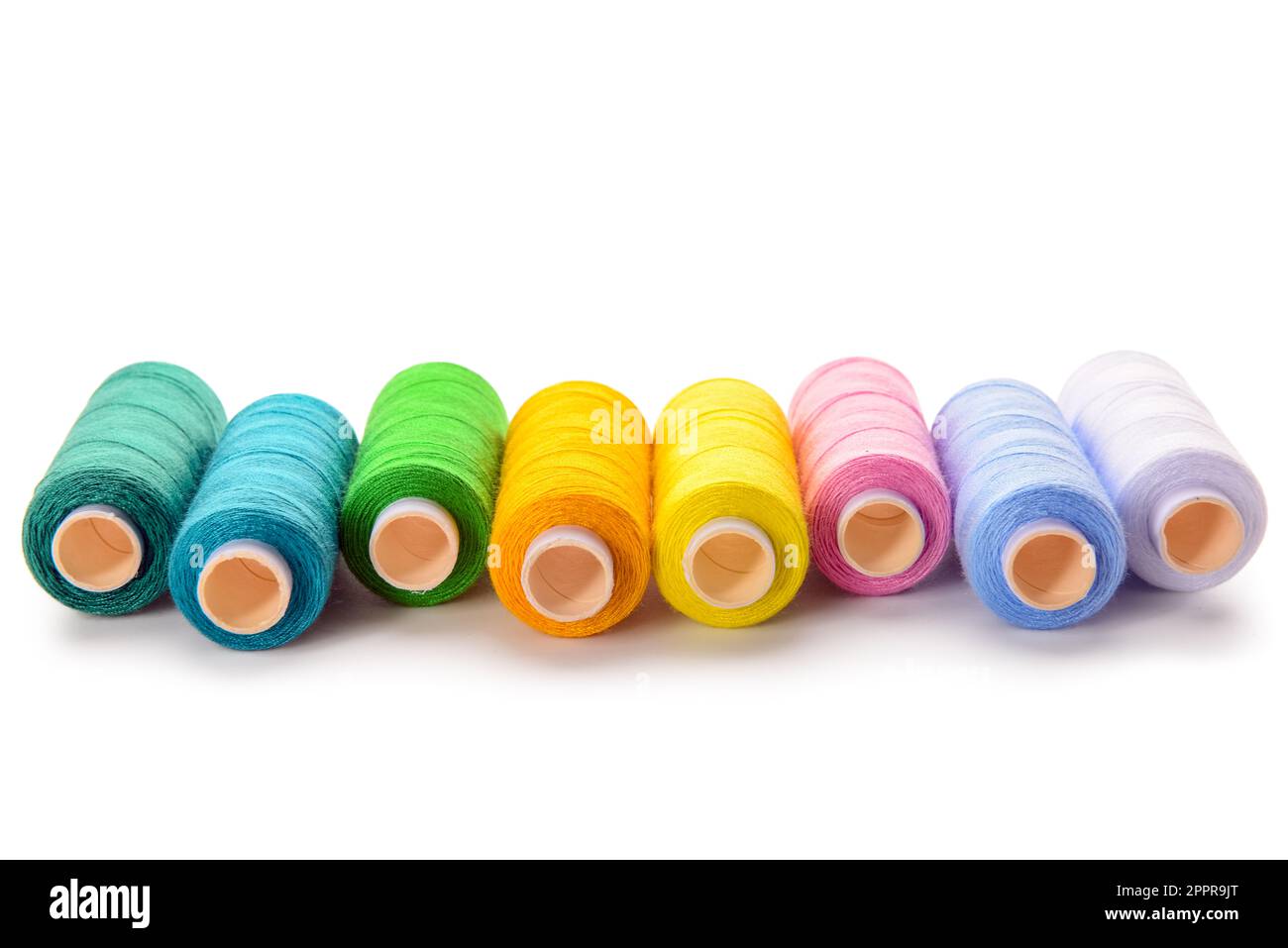 Set of colorful thread spools on white background Stock Photo - Alamy