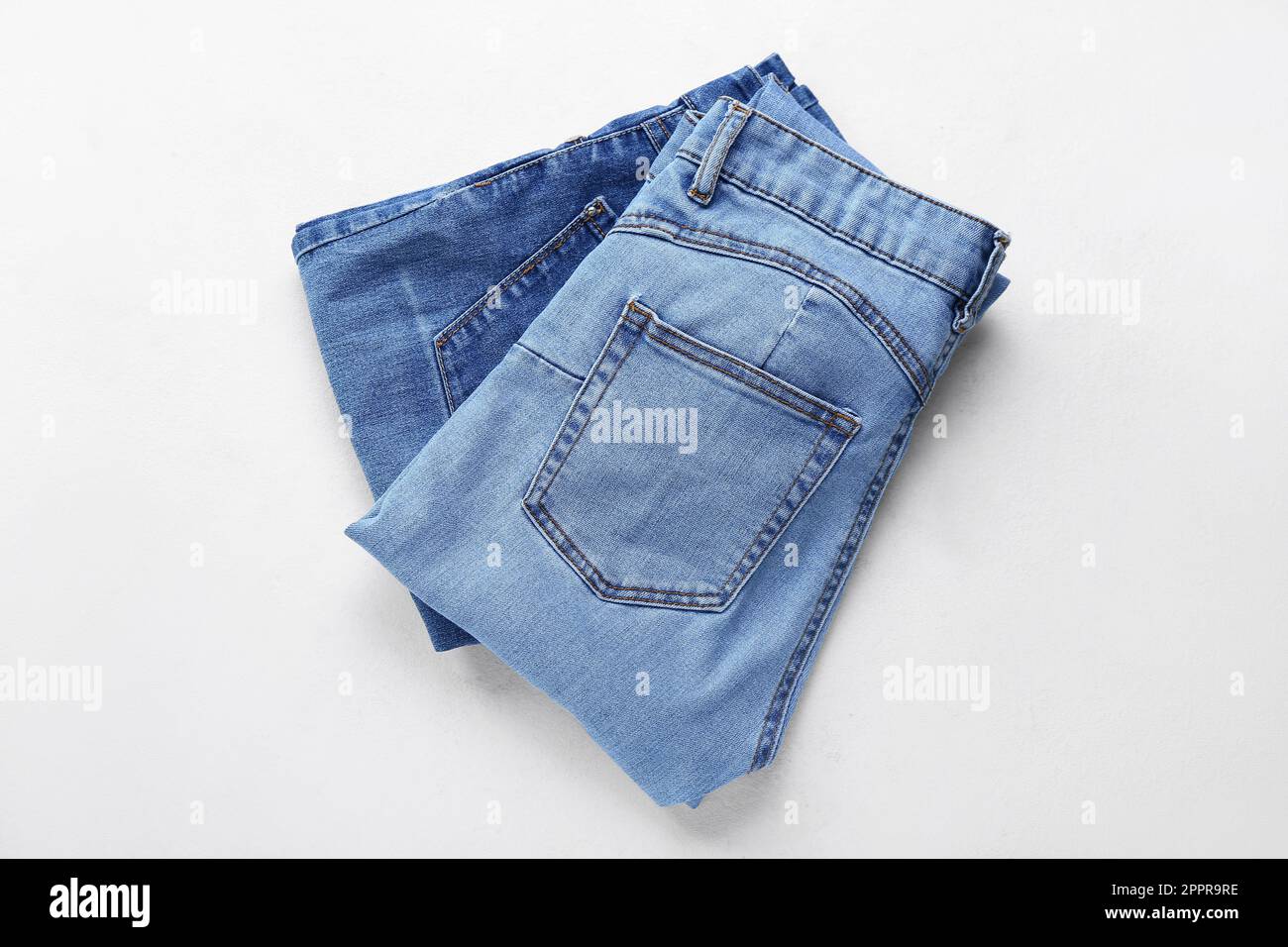 Stylish jeans on white background Stock Photo - Alamy