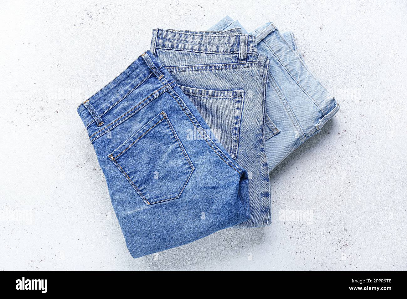 Stylish jeans on white background Stock Photo - Alamy