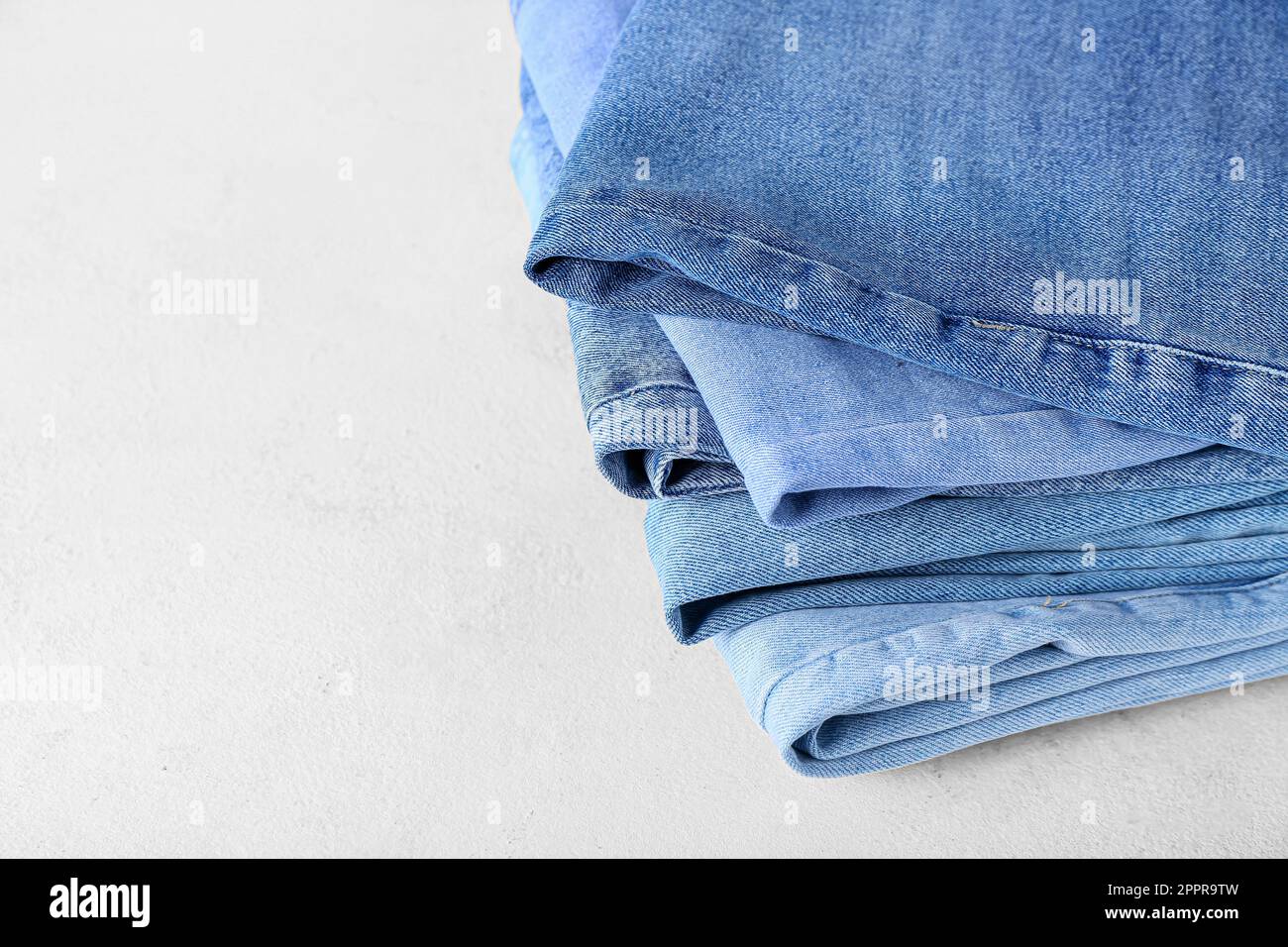 Stack of jeans on white background, closeup Stock Photo - Alamy