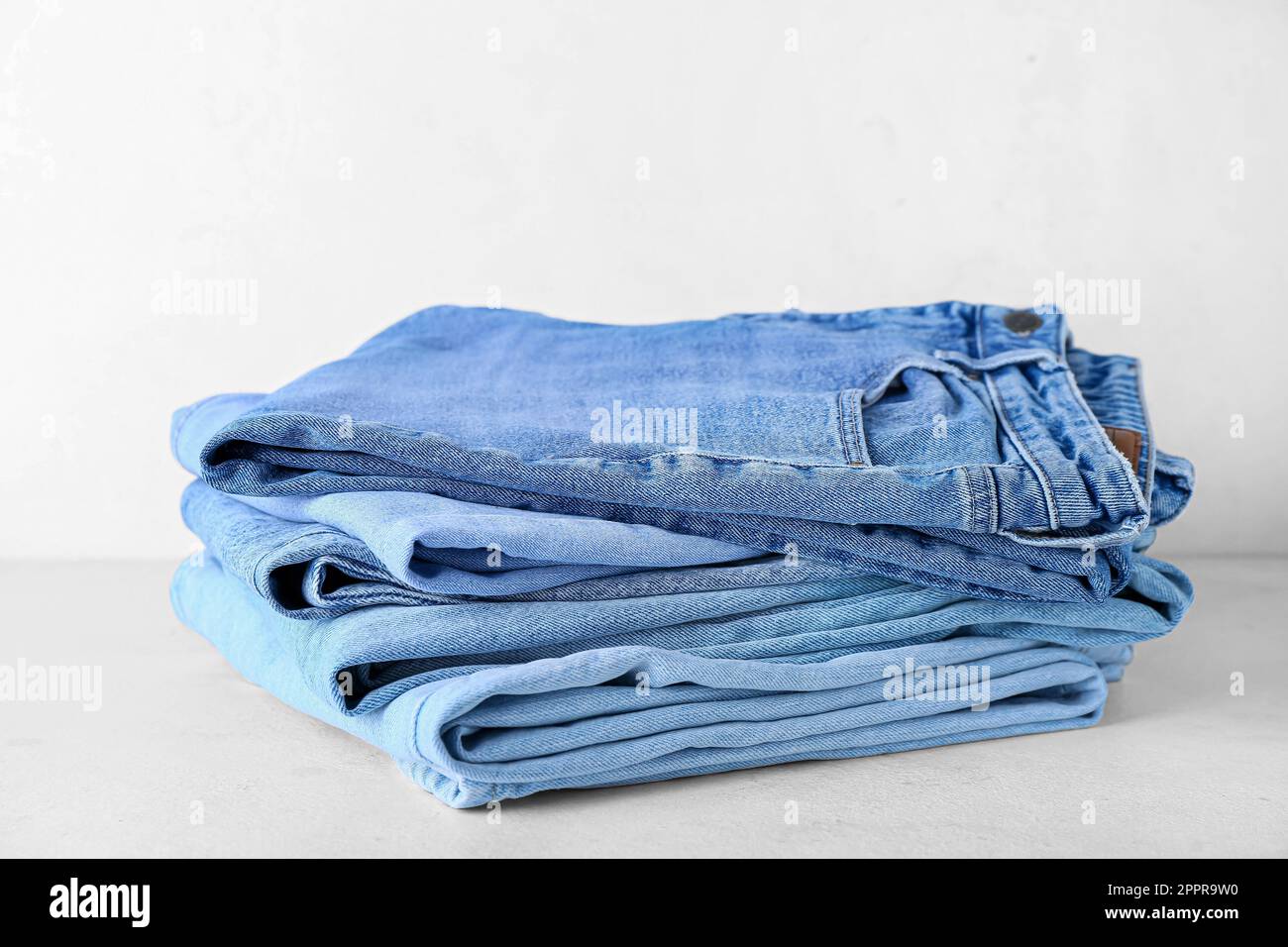 Stack of jeans on white background Stock Photo - Alamy