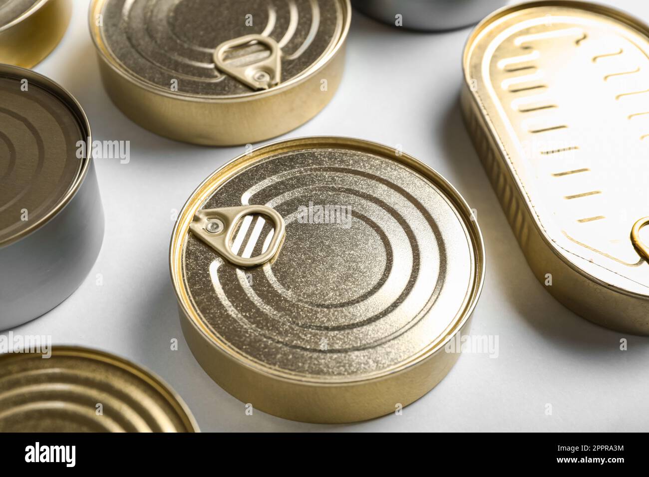 Assortment of tin cans with fish on white background Stock Photo - Alamy