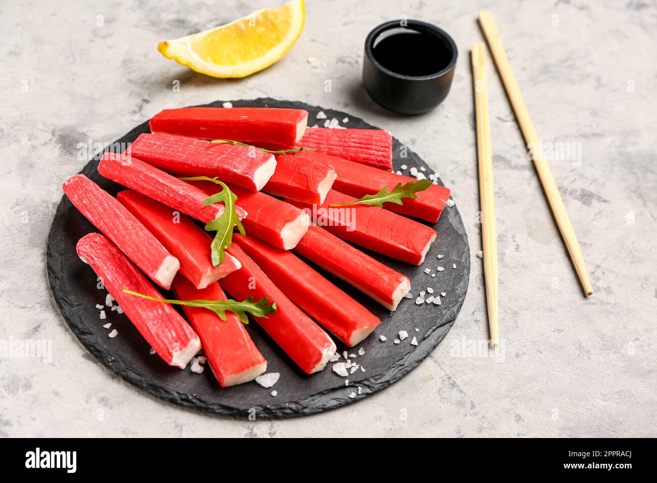 Slate board with tasty crab sticks on grunge background Stock Photo - Alamy