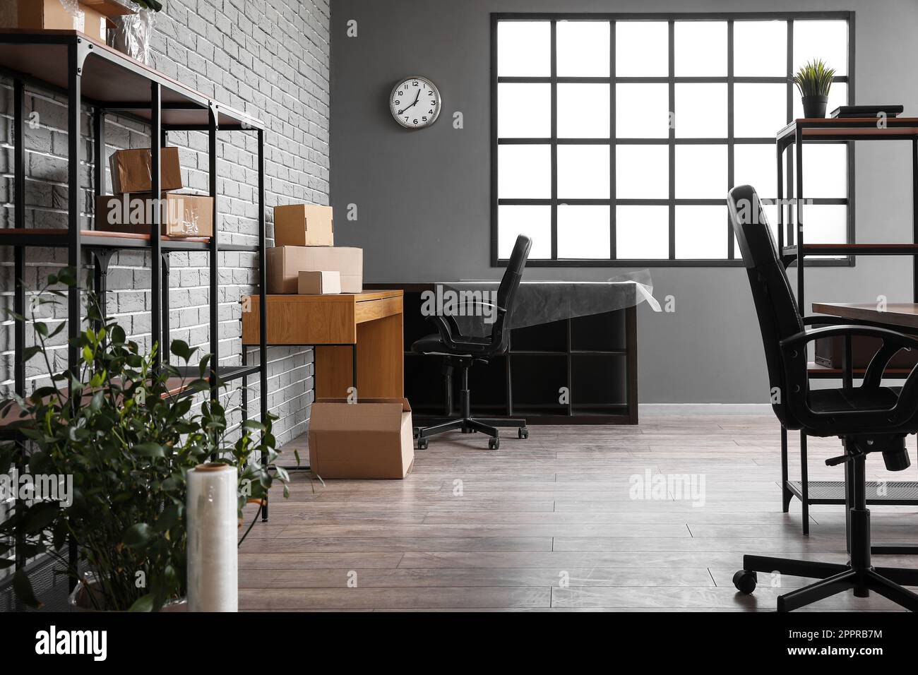 Workplace with cardboard boxes in office on moving day Stock Photo - Alamy