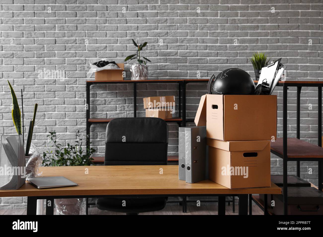 Workplace with cardboard boxes in office on moving day Stock Photo - Alamy