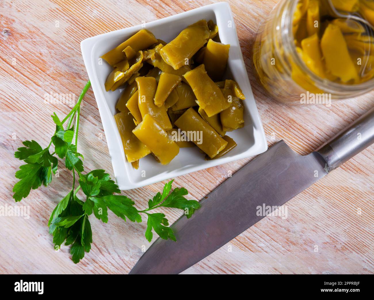 Pickled flat beans with parsley Stock Photo - Alamy