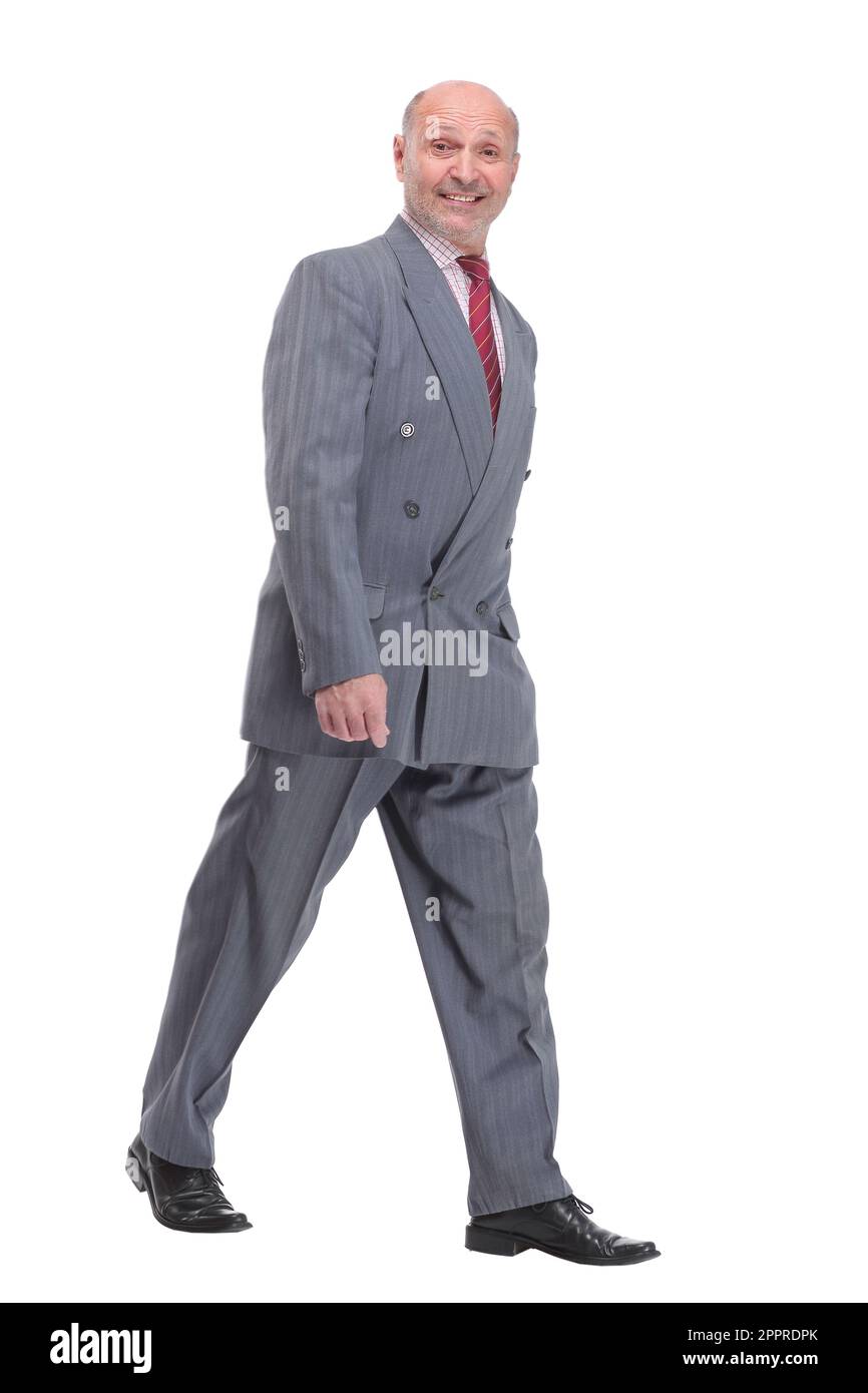 full length picture of a senior business man walking towards the camera ...