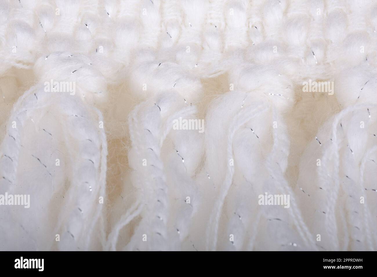 Closeup fringe on soft knit throw blanket is crisp white. Decor, design ...