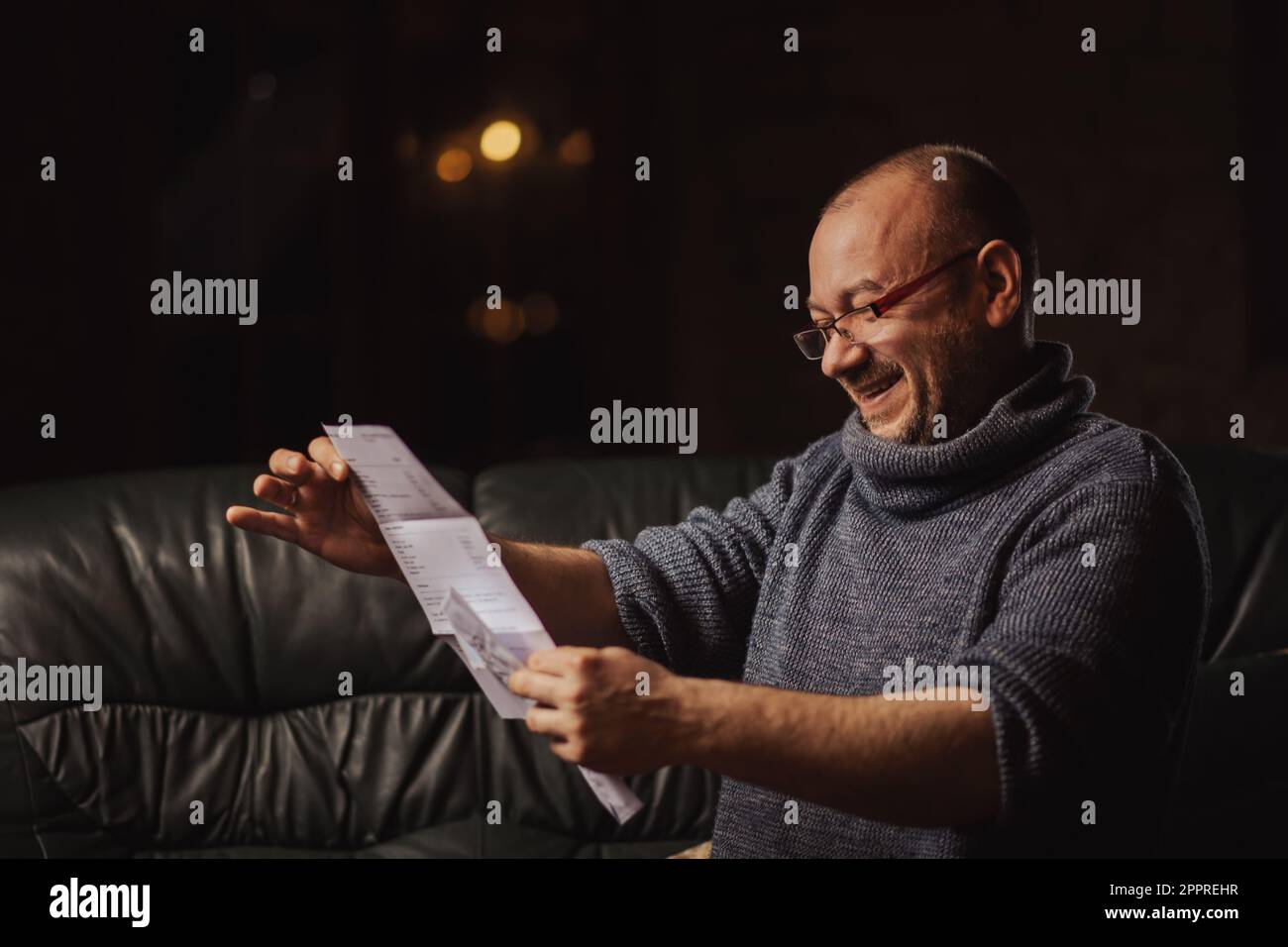 Joyful letter from a middle-aged man in glasses in his hands. Good news ...