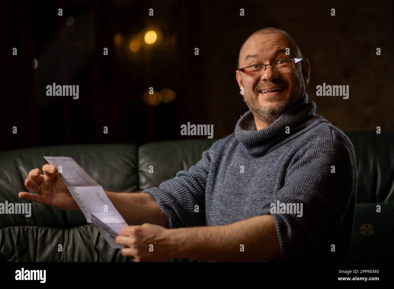 Joyful letter from a middle-aged man in glasses in his hands. Good news ...