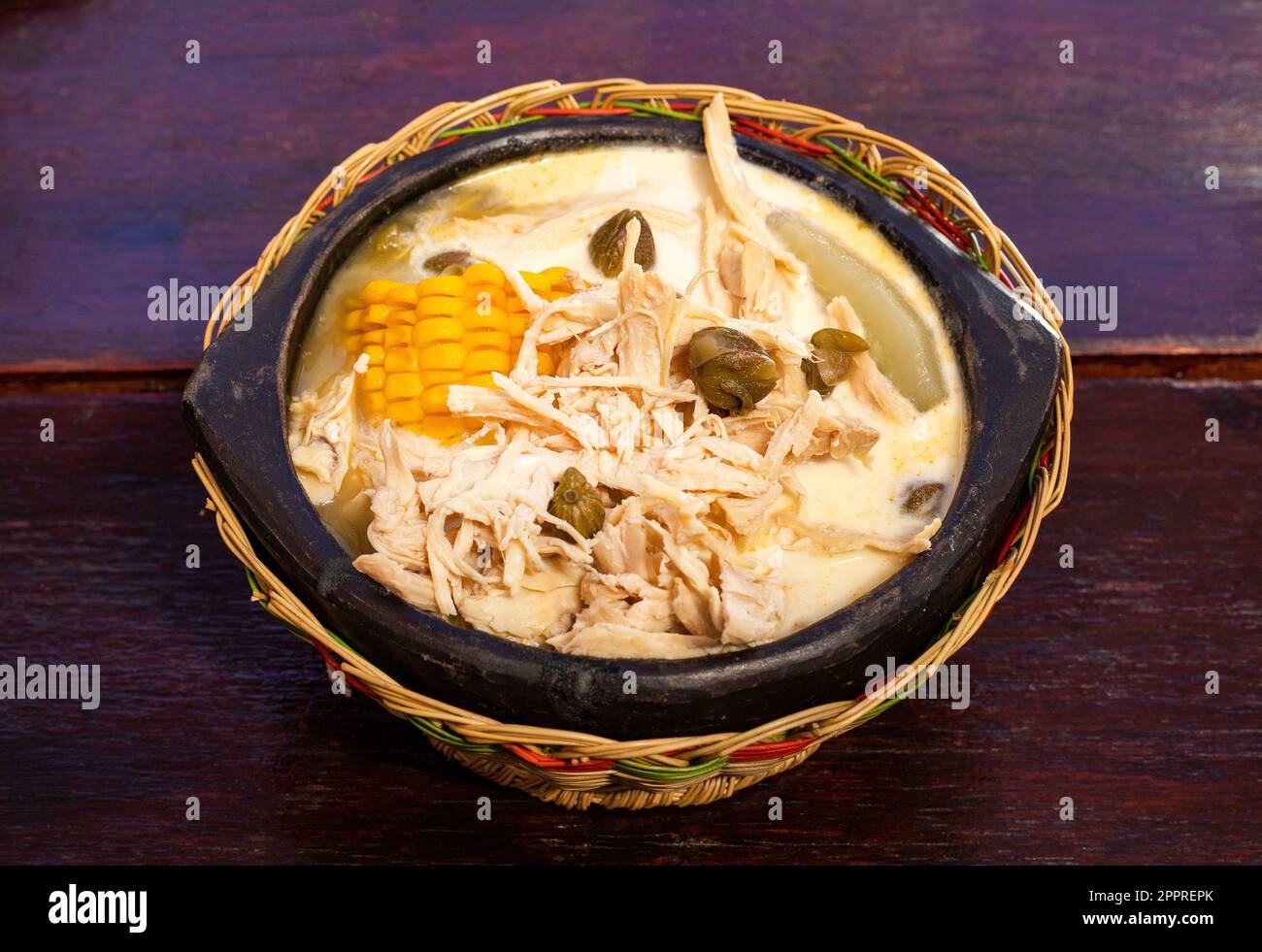 Ajiaco, traditional Colombian food, accompanied by shredded chicken ...