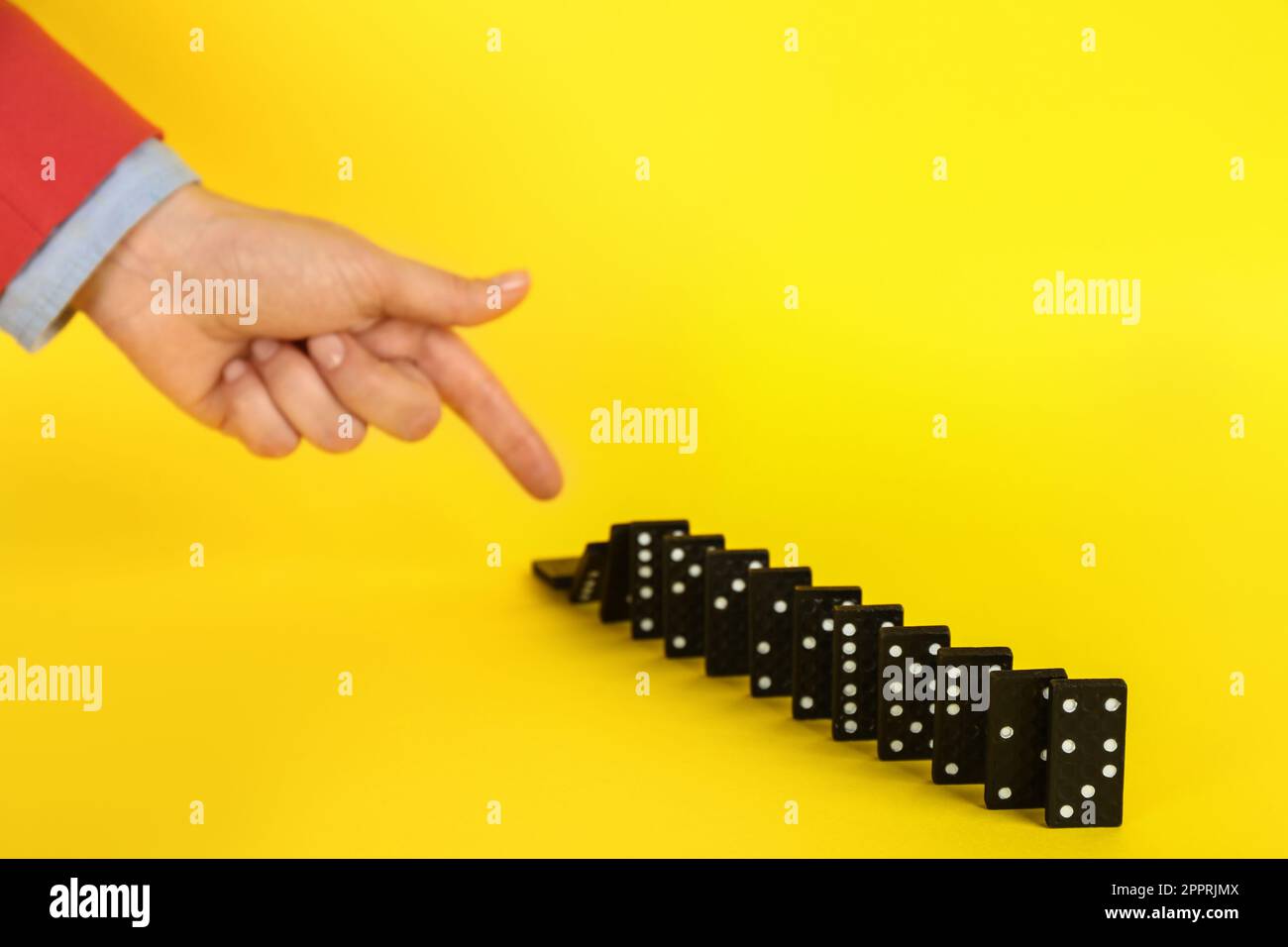 Finger pushing dominoes hi-res stock photography and images - Alamy