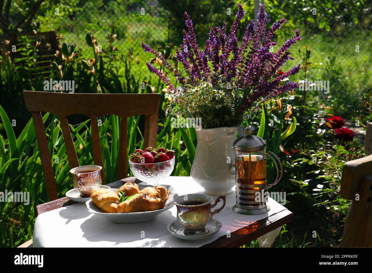 Beautiful bouquet of wildflowers on table served for tea drinking in ...