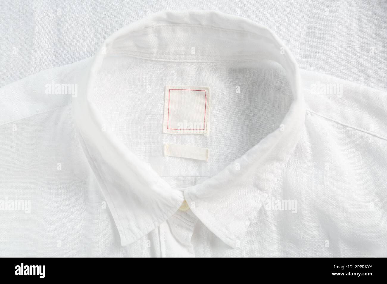 Blank clothing labels on white shirt, top view Stock Photo - Alamy