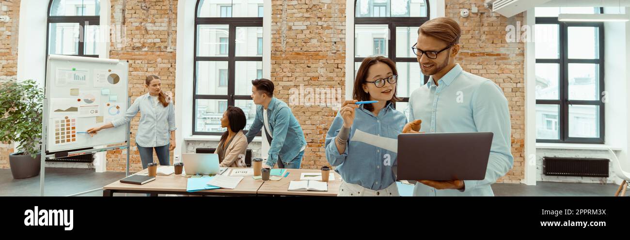 Young woman amd man checking teamwork. Colleague motivation for success ...