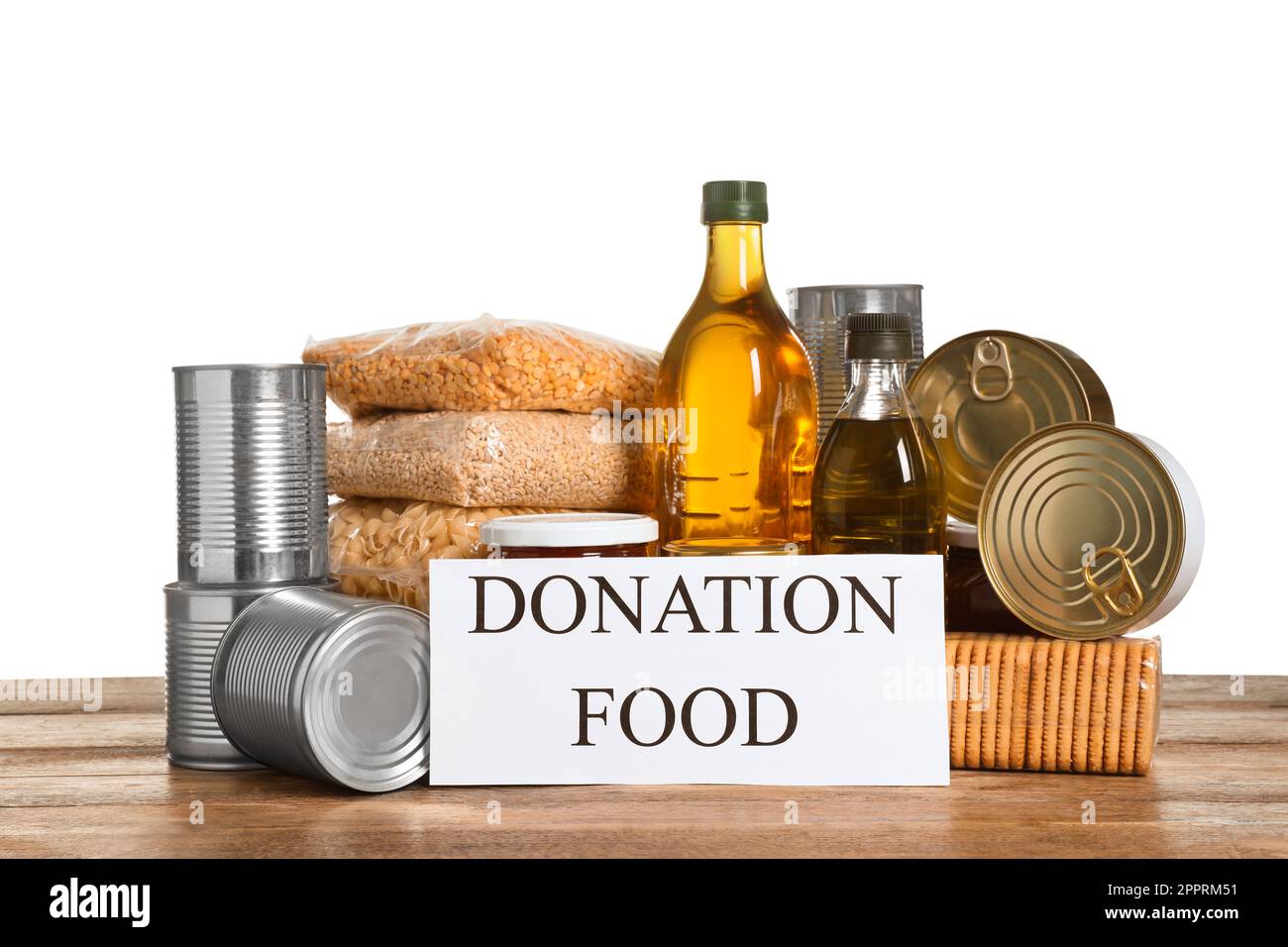 Card with words Donation Food and different products on wooden table ...