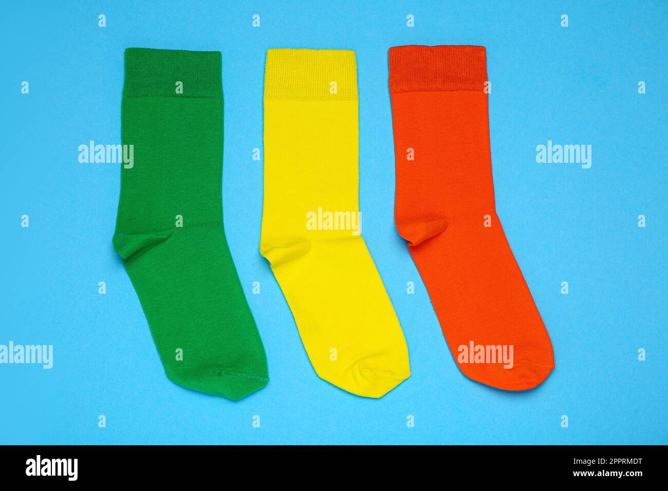 Different socks on light blue background, flat lay Stock Photo - Alamy