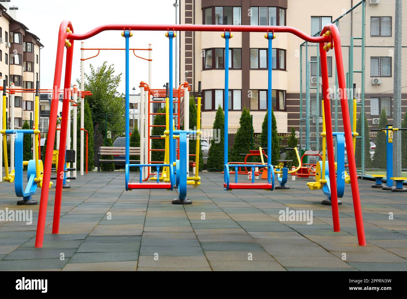 Empty outdoor children's playground with swings in residential area ...