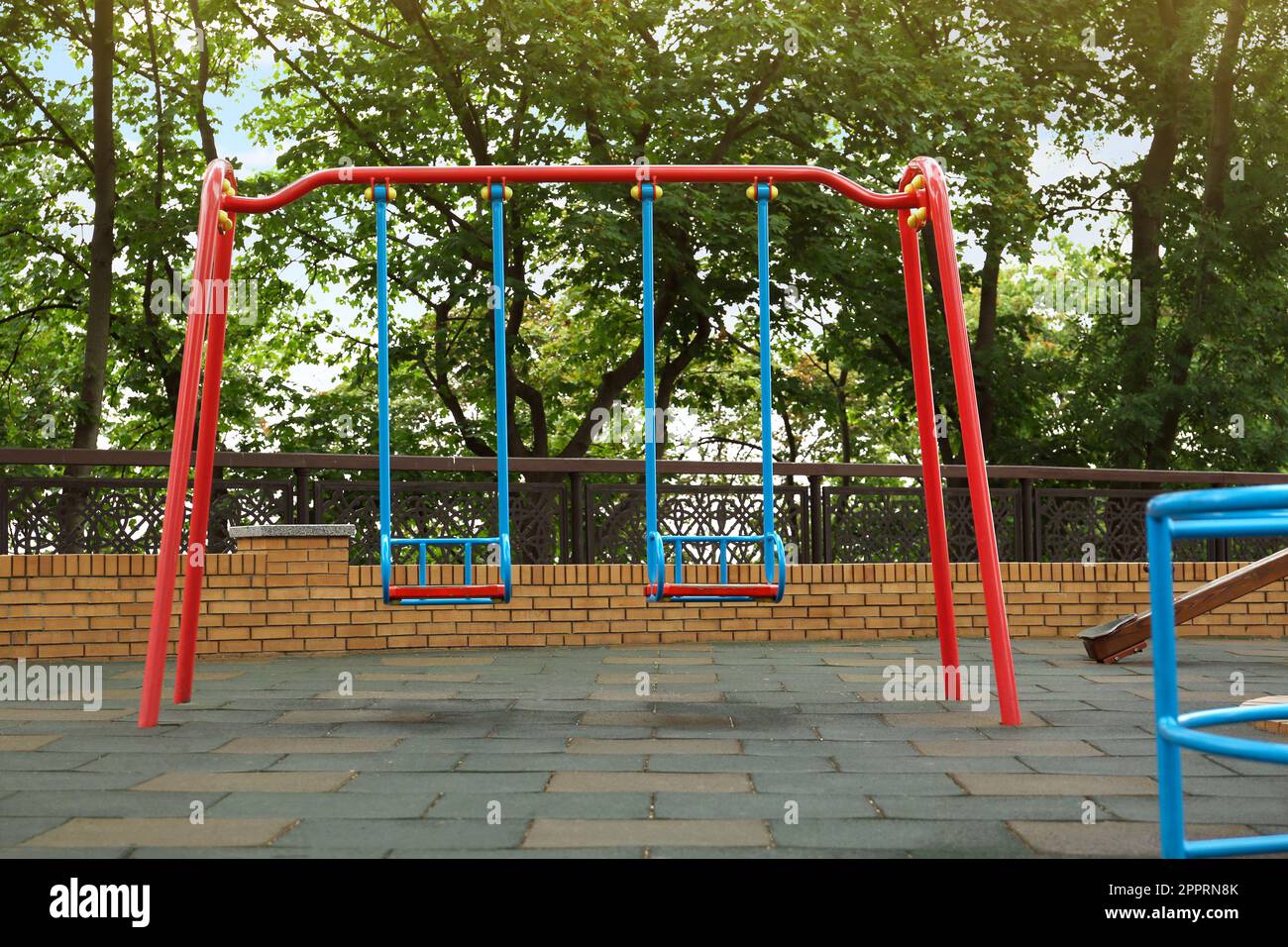 Children's playground with new colorful swing set Stock Photo - Alamy