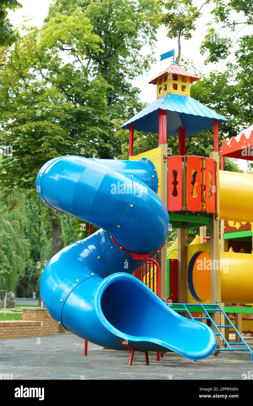 New colorful castle playhouse with slide on children's playground Stock ...