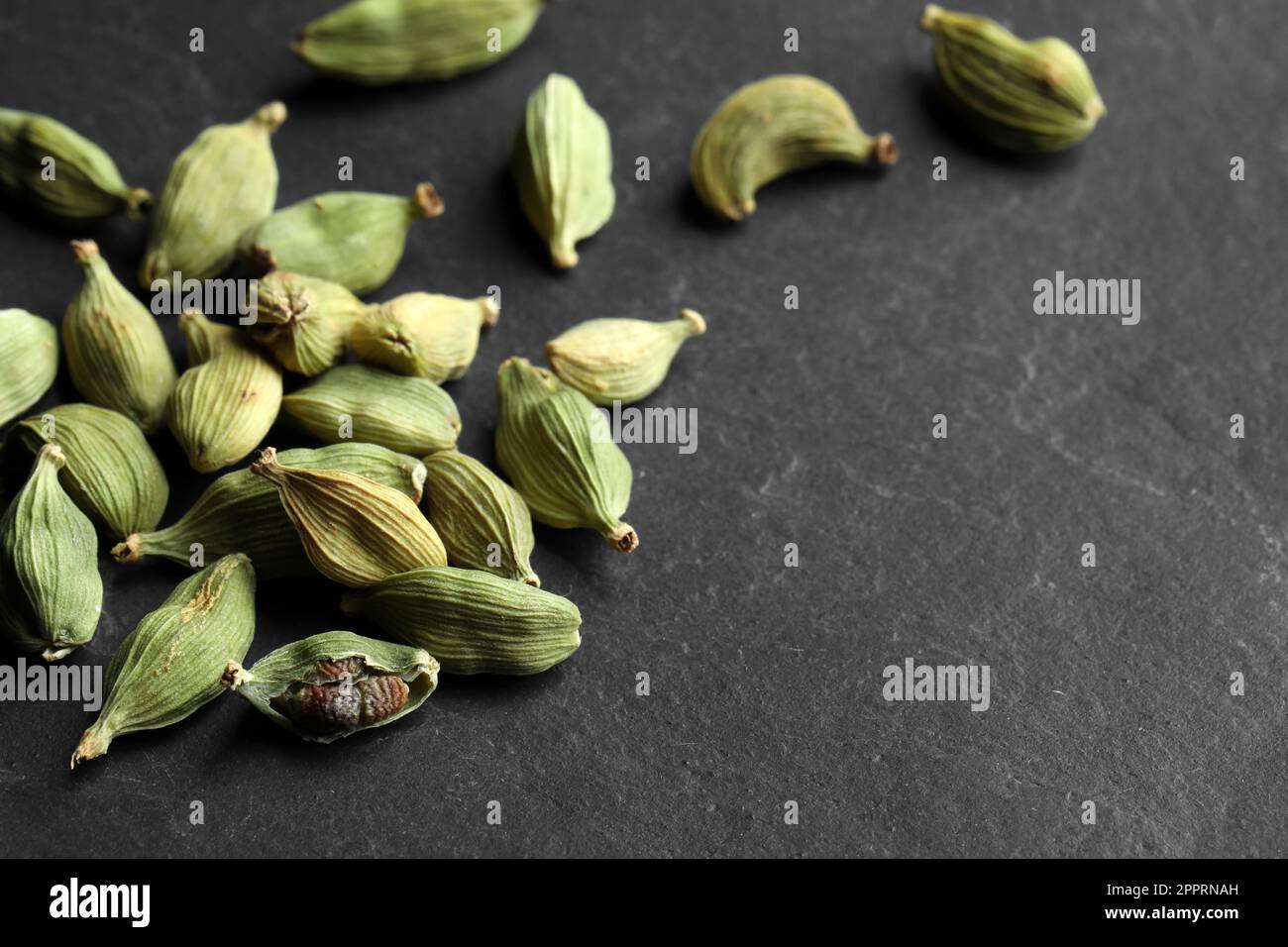 Pile of dry cardamom pods on black table, space for text Stock Photo ...
