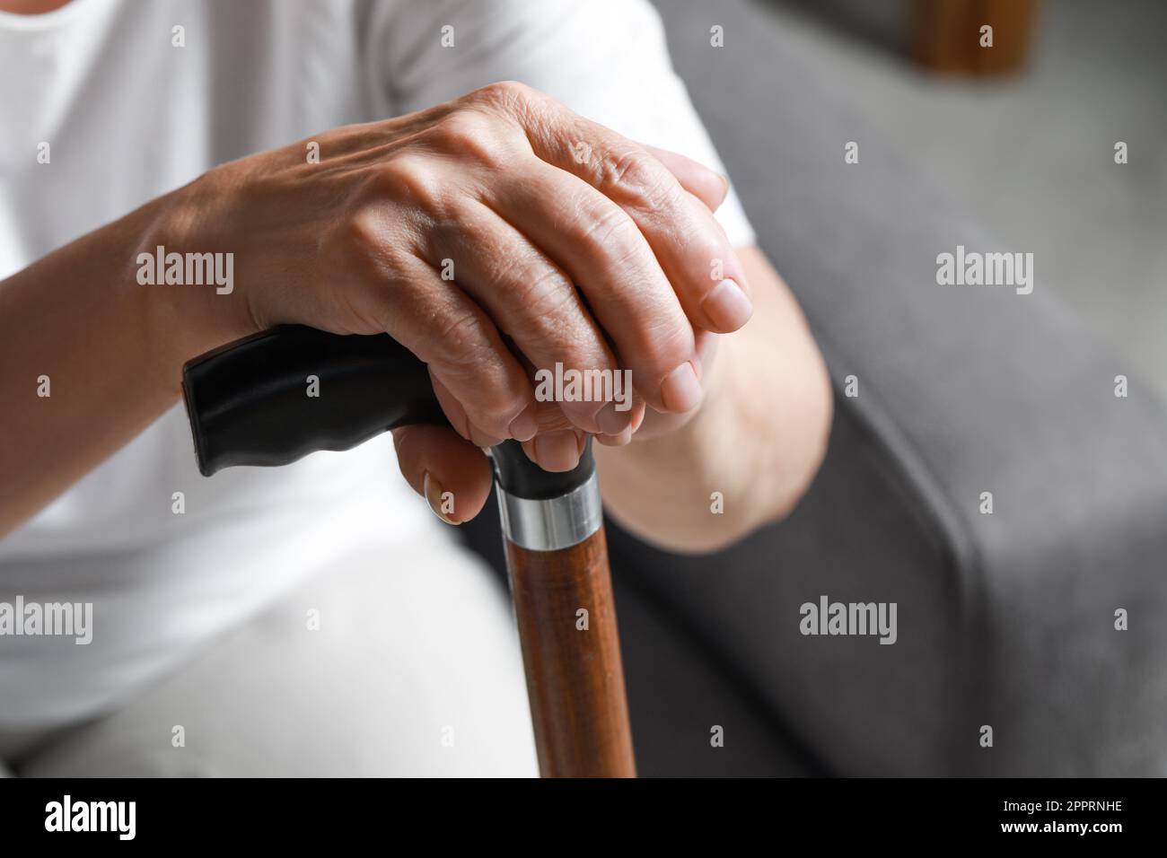 Elderly woman with walking cane indoors, closeup. Home care service ...