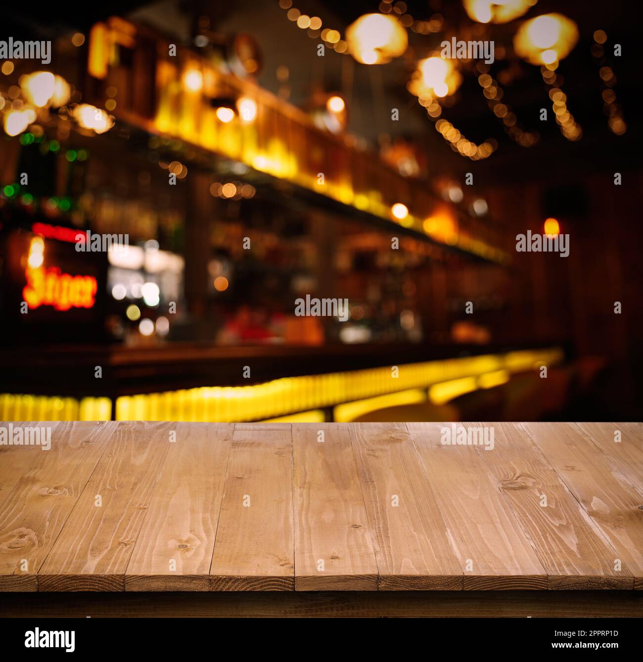Empty wooden surface and blurred view of bar interior. Space for design ...