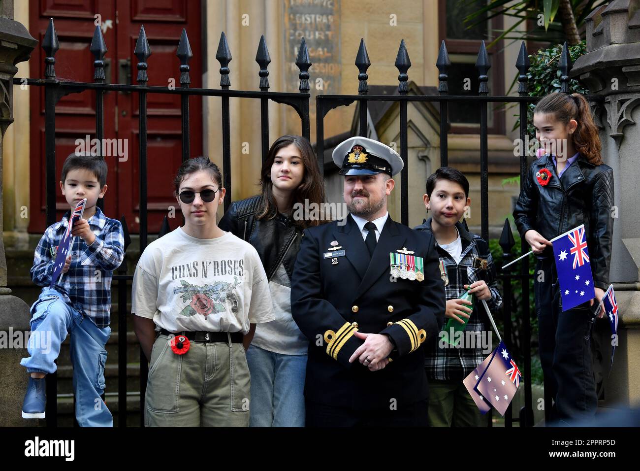 A member of the Royal Australian Navy watches the Anzac Day March in ...