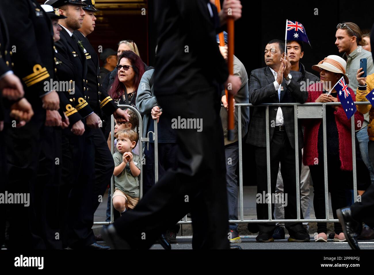 Members of the public watch the Anzac Day March in Sydney, Tuesday ...