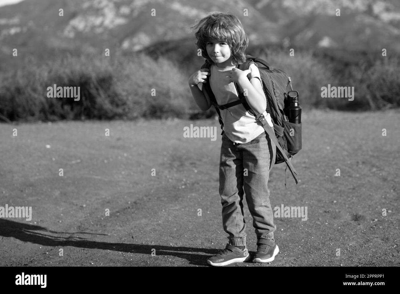 Kid with backpack hiking in scenic mountains. Boy child local tourist ...