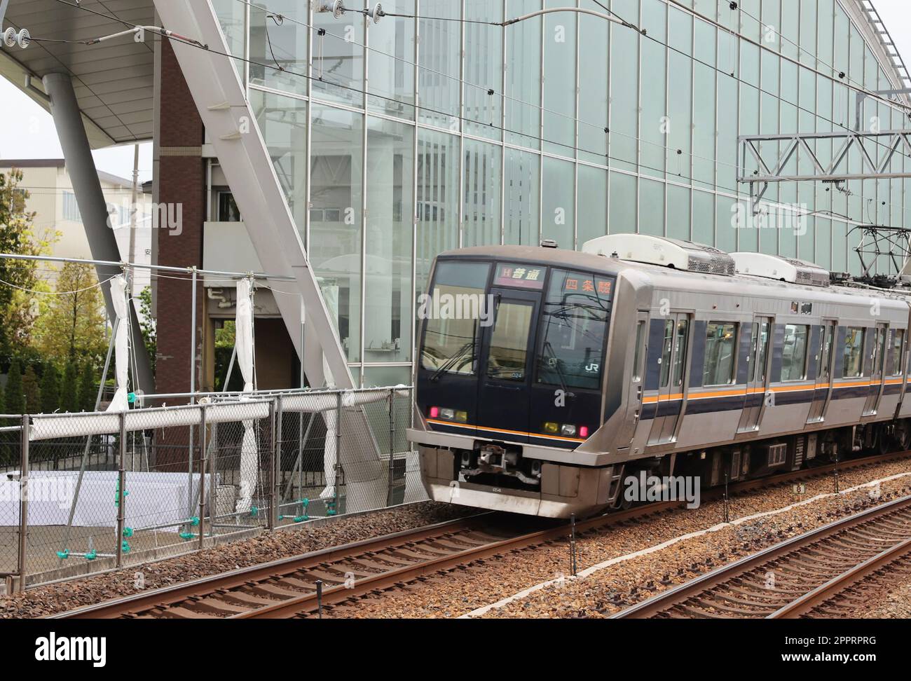 A train passes near the site of the derailment accident in Amagasaki City, Hyogo Prefecture on ...