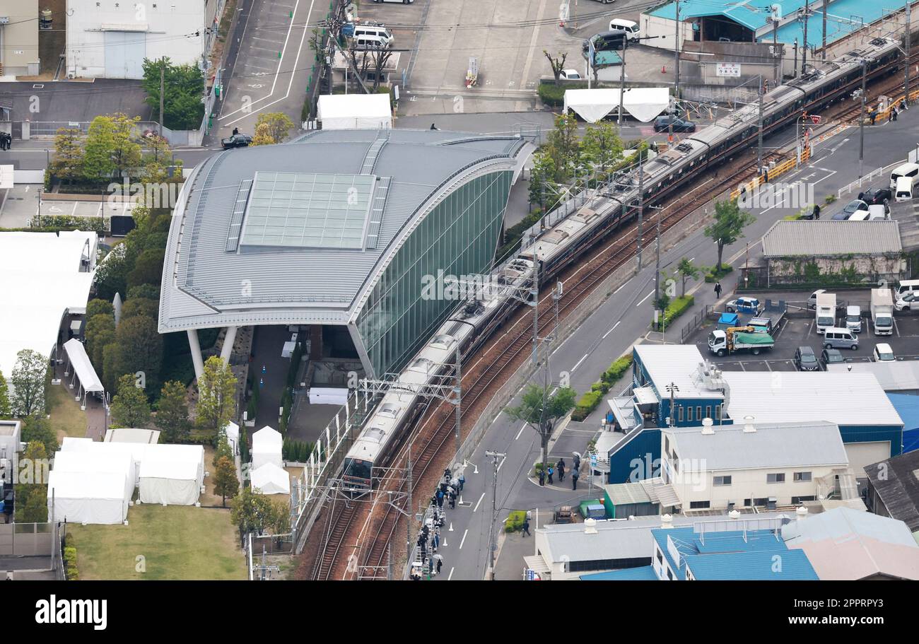 A train passes near the site of the derailment accident in Amagasaki City, Hyogo Prefecture on ...