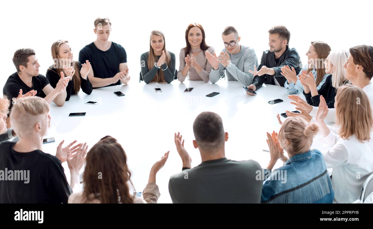 group of young people applauding, sitting at a round table Stock Photo ...