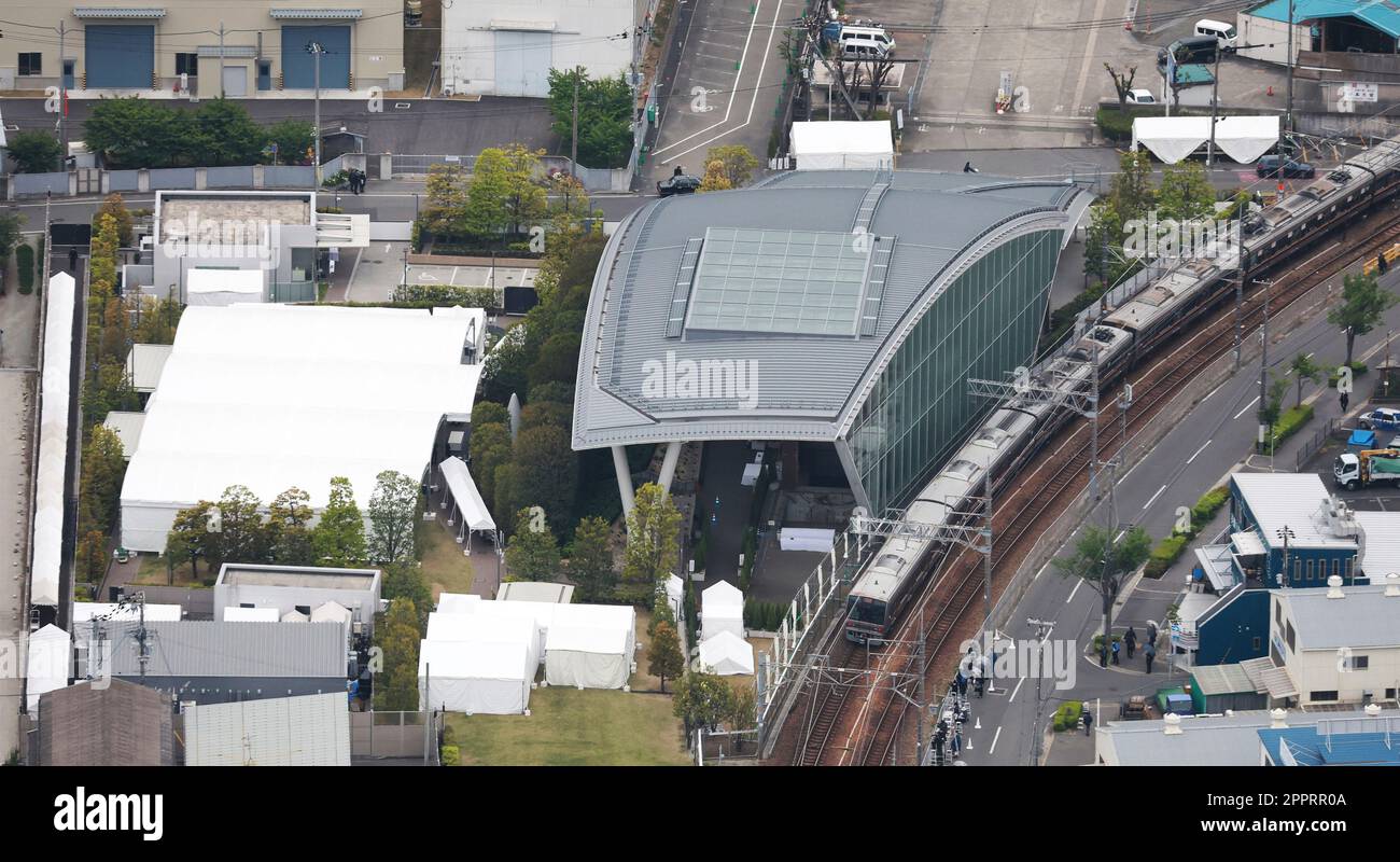 A train passes near the site of the derailment accident in Amagasaki City, Hyogo Prefecture on ...
