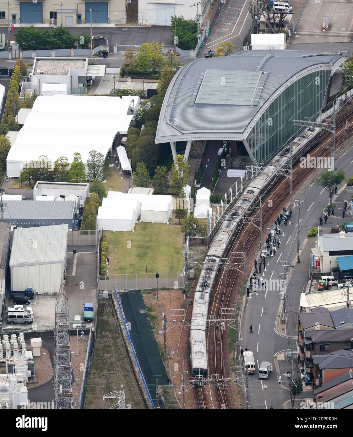 A train passes near the site of the derailment accident in Amagasaki City, Hyogo Prefecture on ...