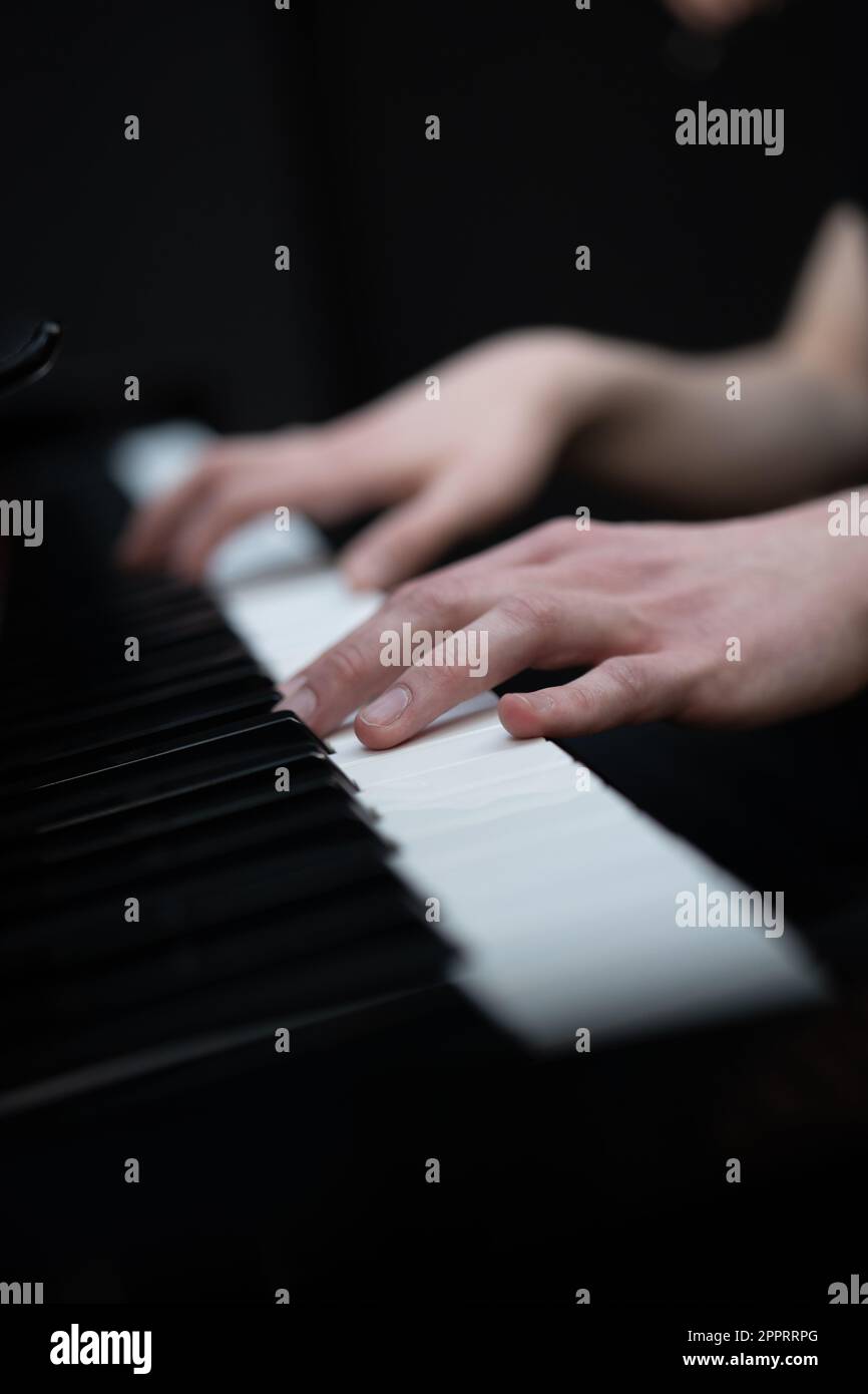 A musician playing the piano. Pianist's hands on the keyboard Stock Photo - Alamy