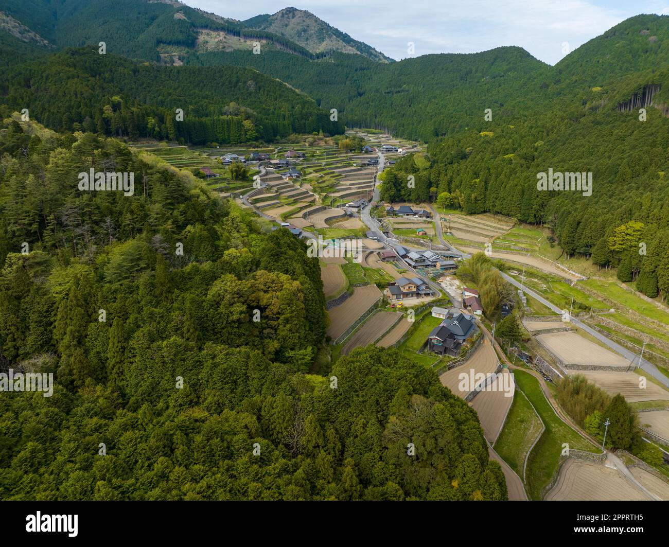 Aerial view of terraced fields and small farms in Japanese mountain ...